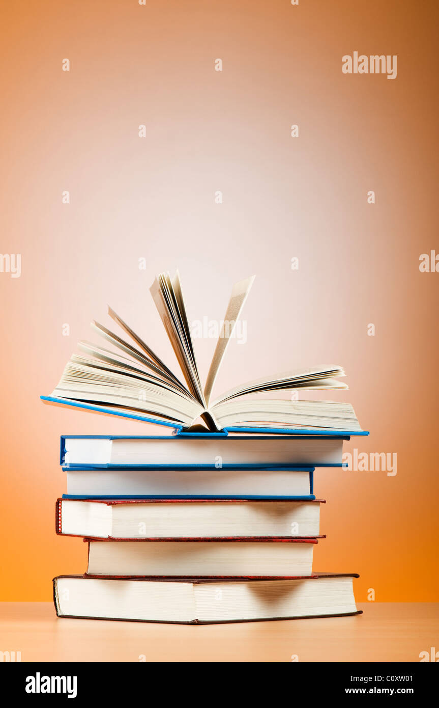 Stack of text books against gradient background Stock Photo - Alamy