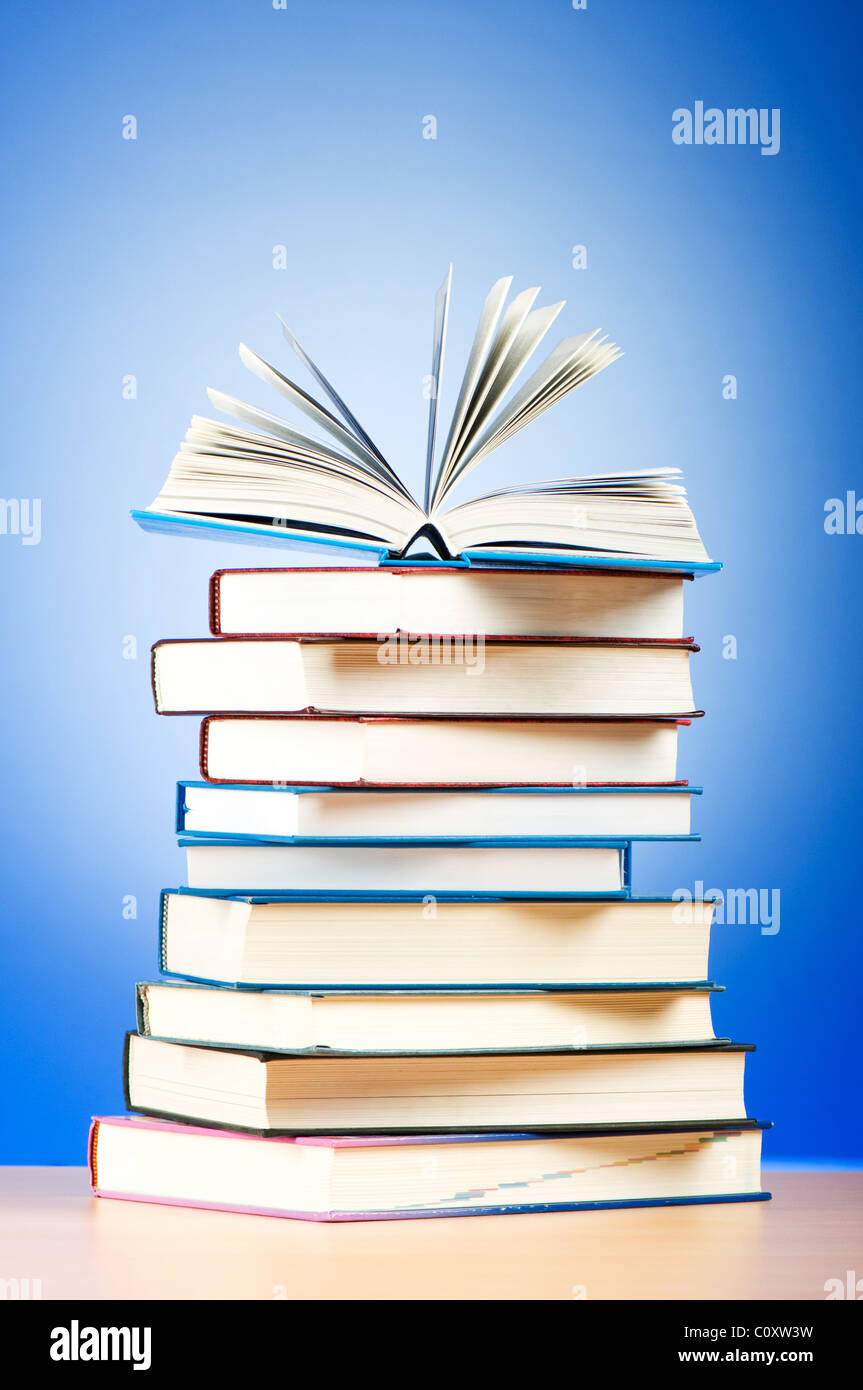 Stack of text books against gradient background Stock Photo - Alamy