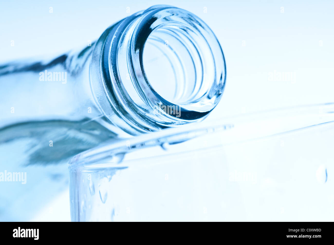 bottle pouring water into glass Stock Photo - Alamy