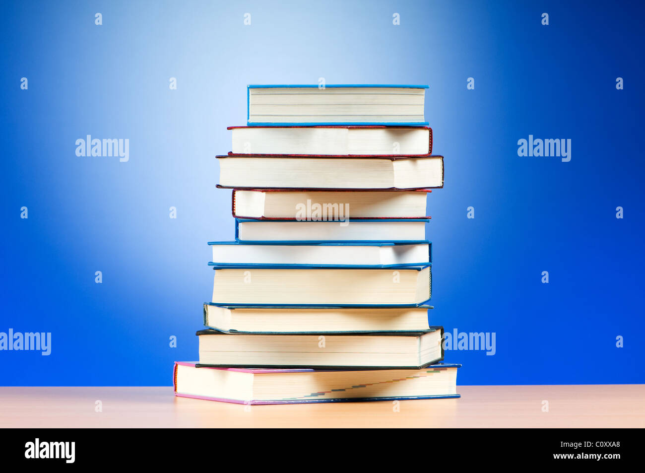Stack of text books against gradient background Stock Photo - Alamy