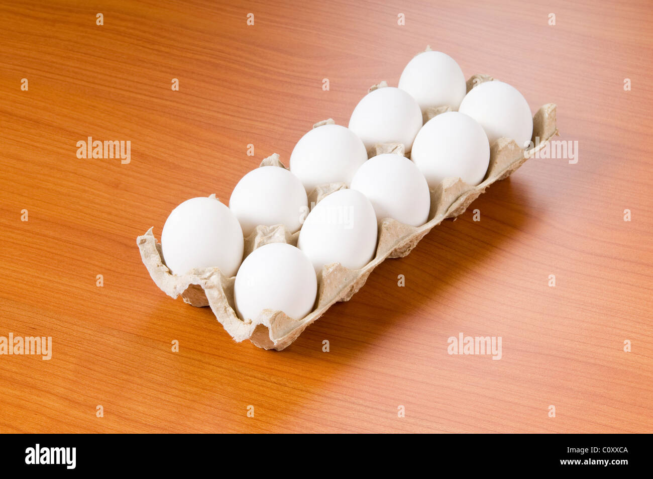 Many white eggs on the wooden table Stock Photo - Alamy