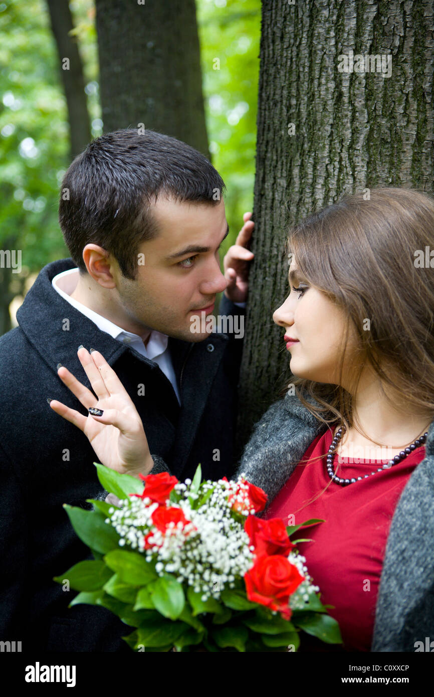 Two young lovers talking to each other in park Stock Photo - Alamy