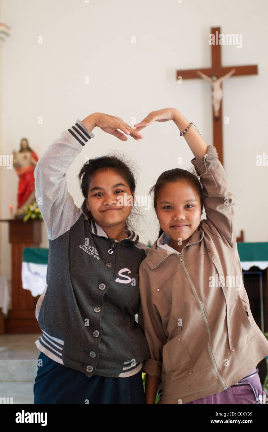 Two girl helpers playing in Catholic church St Teresa, Savannakhet ...
