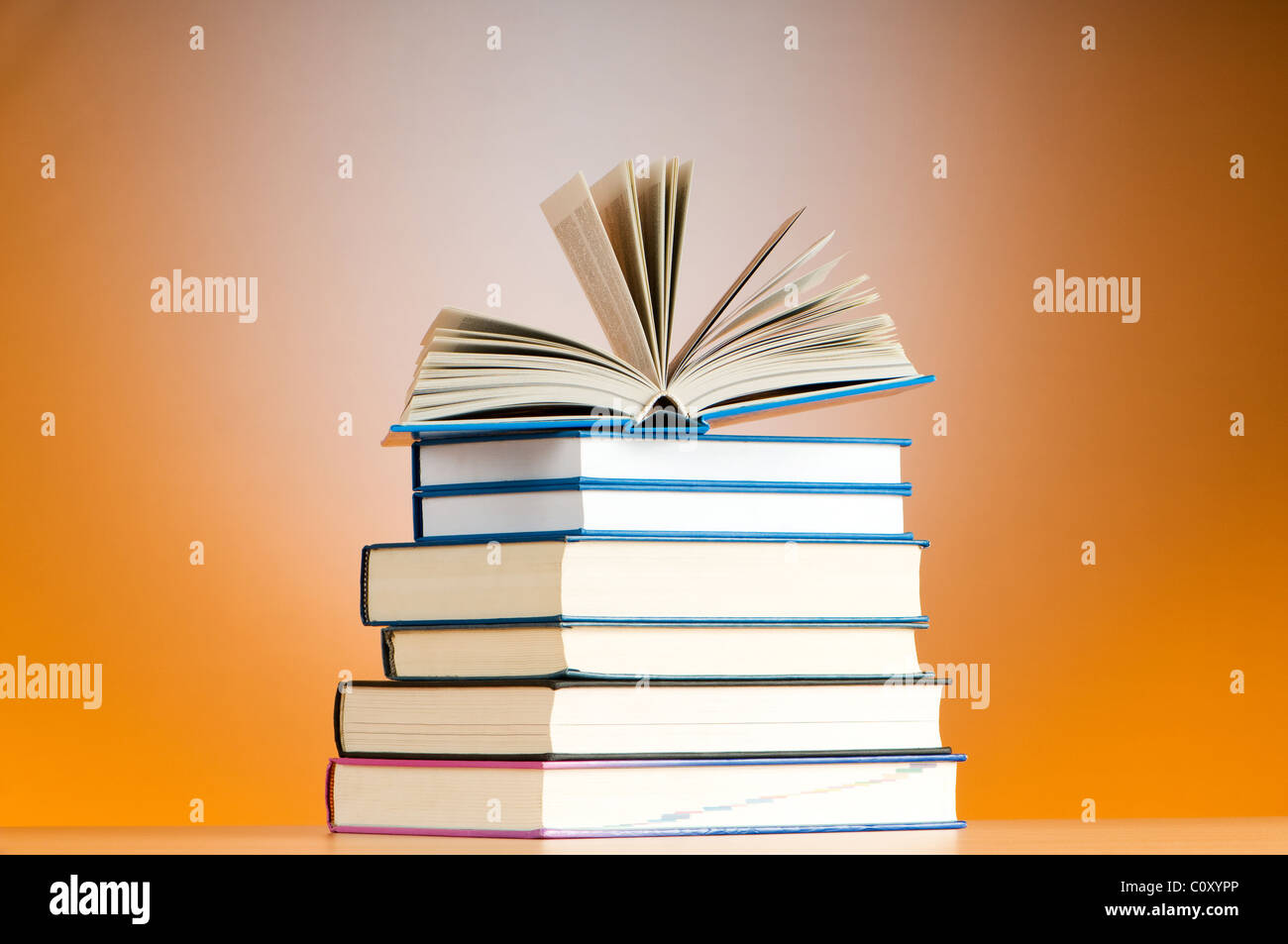 Stack of text books against gradient background Stock Photo - Alamy