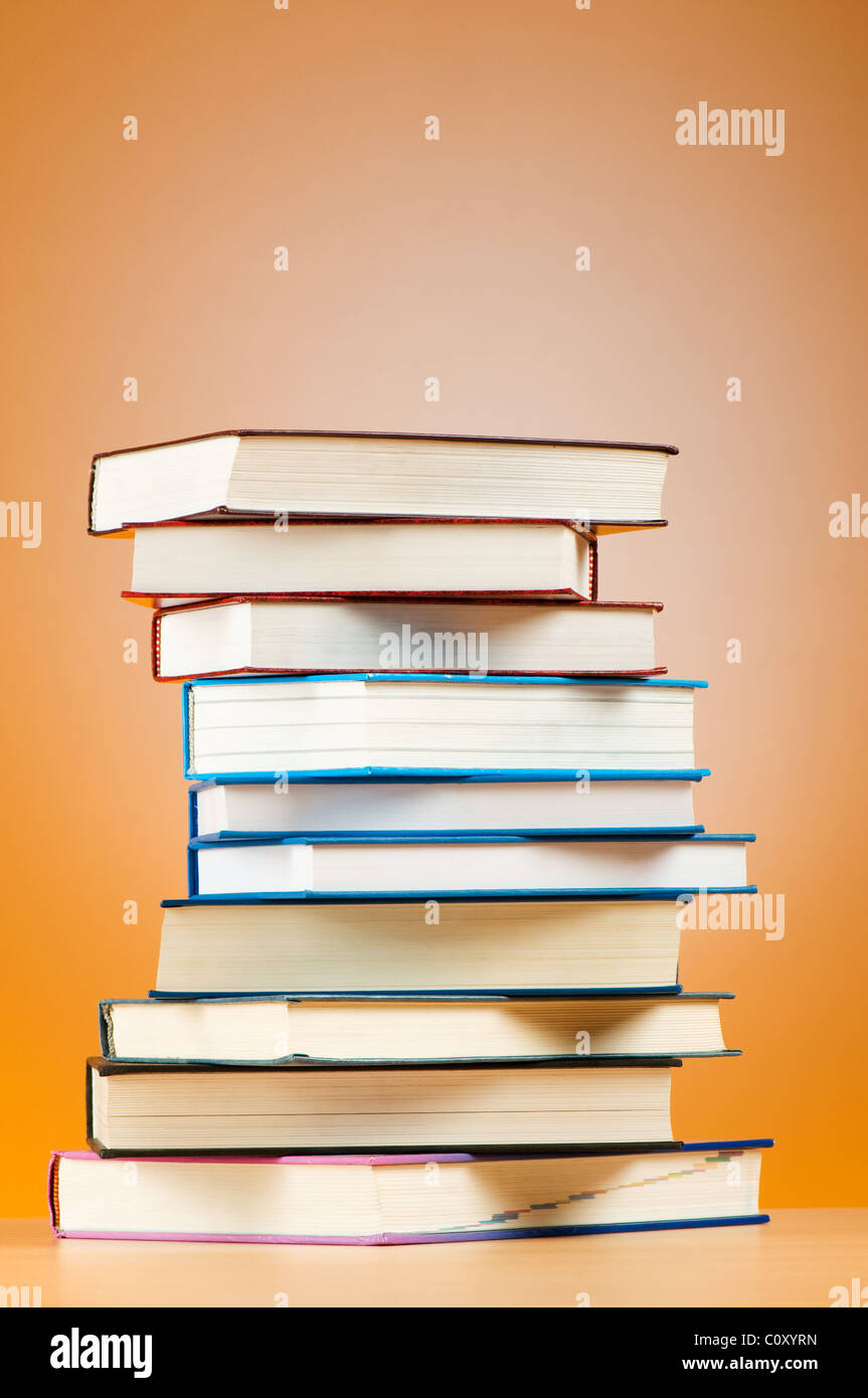 Stack of text books against gradient background Stock Photo - Alamy