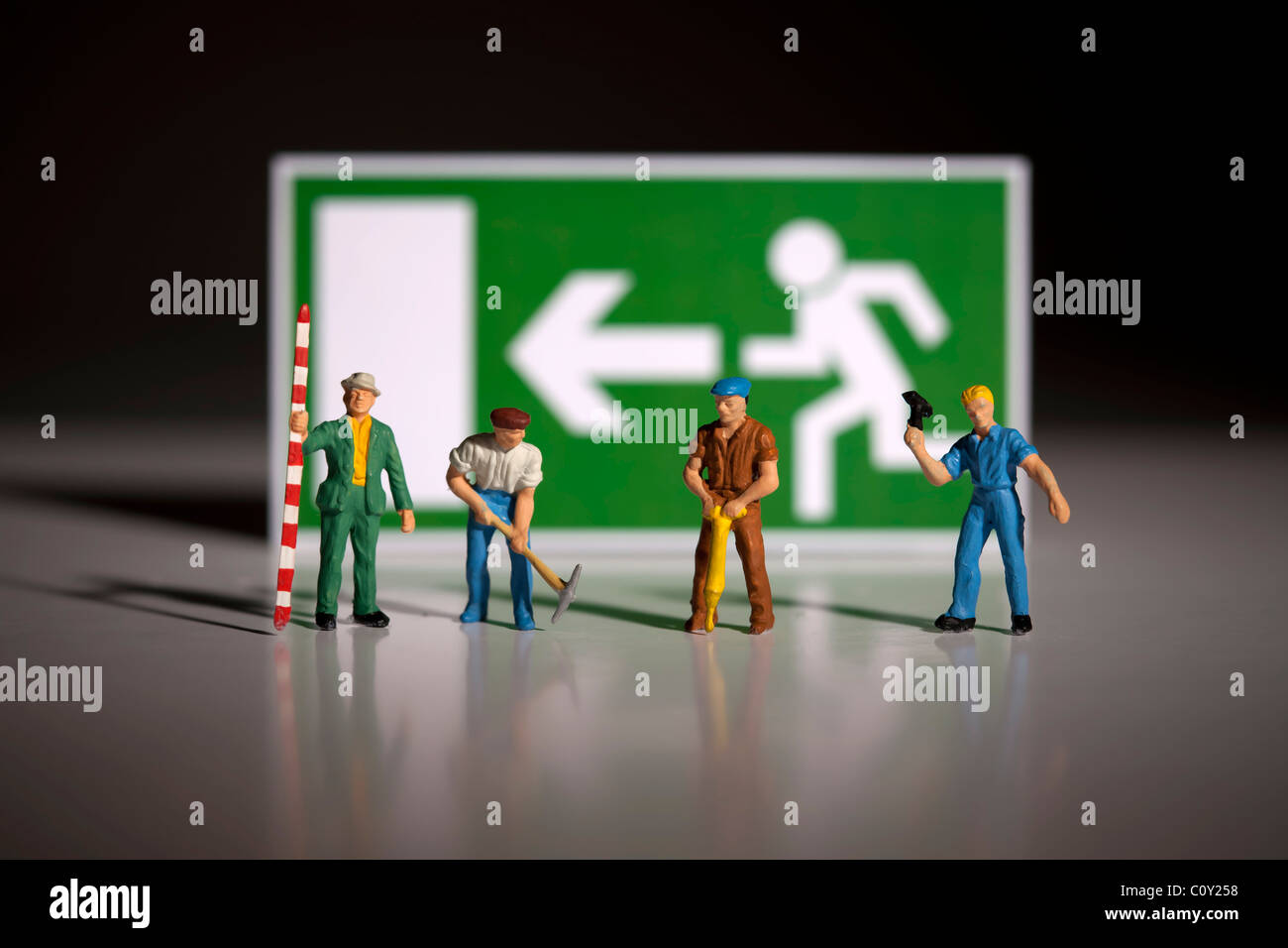 Figures of businessmen in front of emergency exit sign Stock Photo - Alamy