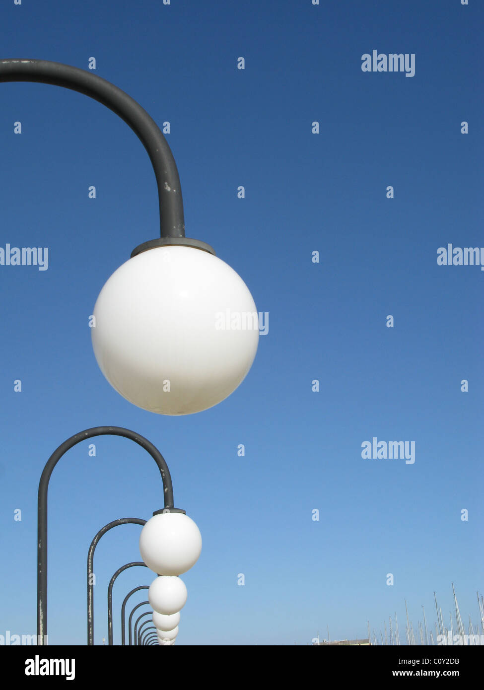 a long row line of street lights and blue sky Stock Photo - Alamy