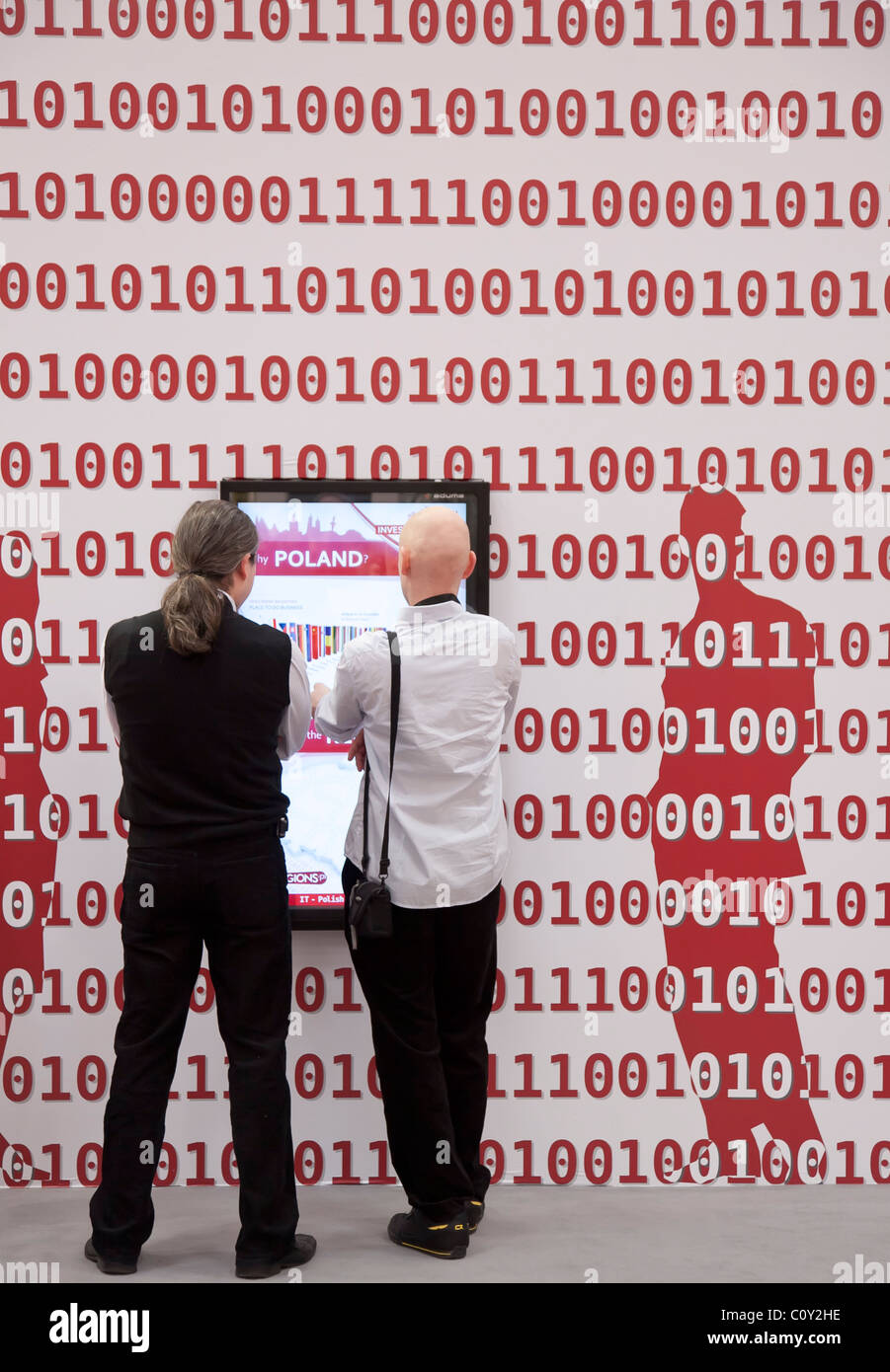 Binary code and people in front of a screen Stock Photo - Alamy