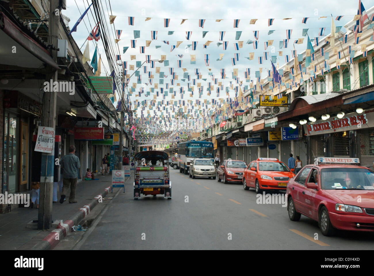 Tuk tuk and a taxi on a road decorated in bounty flags Stock Photo - Alamy