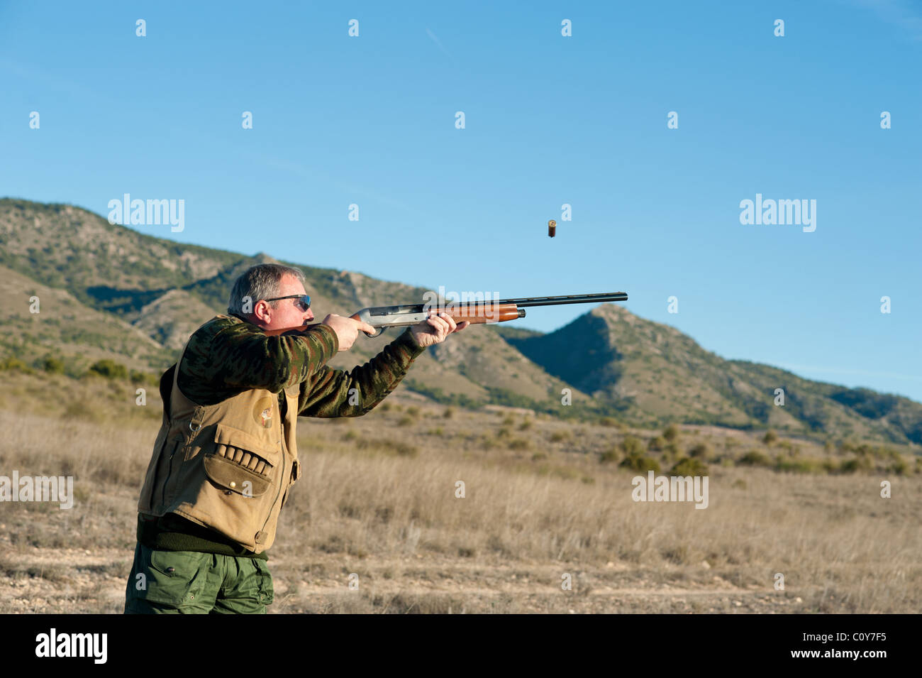 Hunter in action aiming and shooting his rifle Stock Photo - Alamy