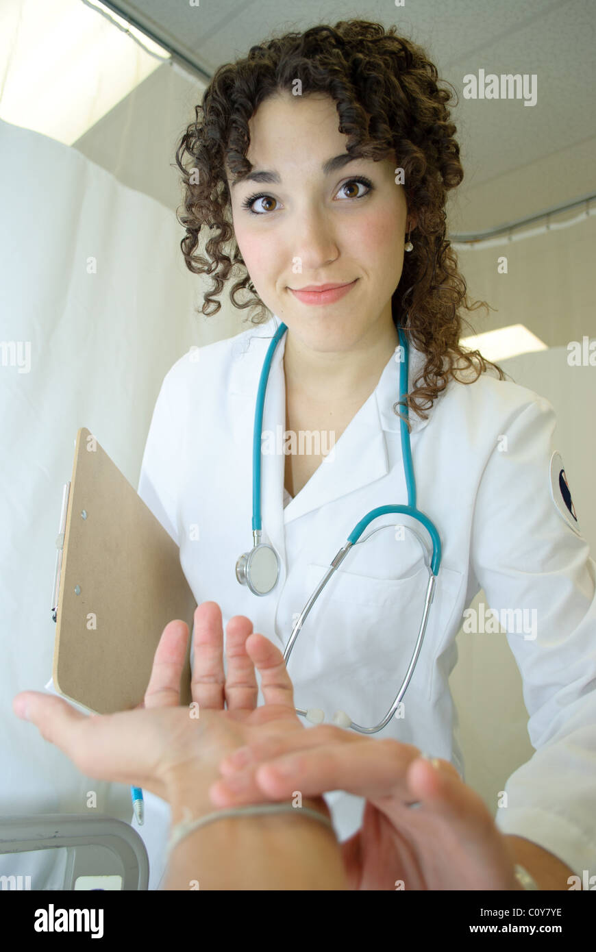 Medical student checking the heart rate of a patient Stock Photo - Alamy