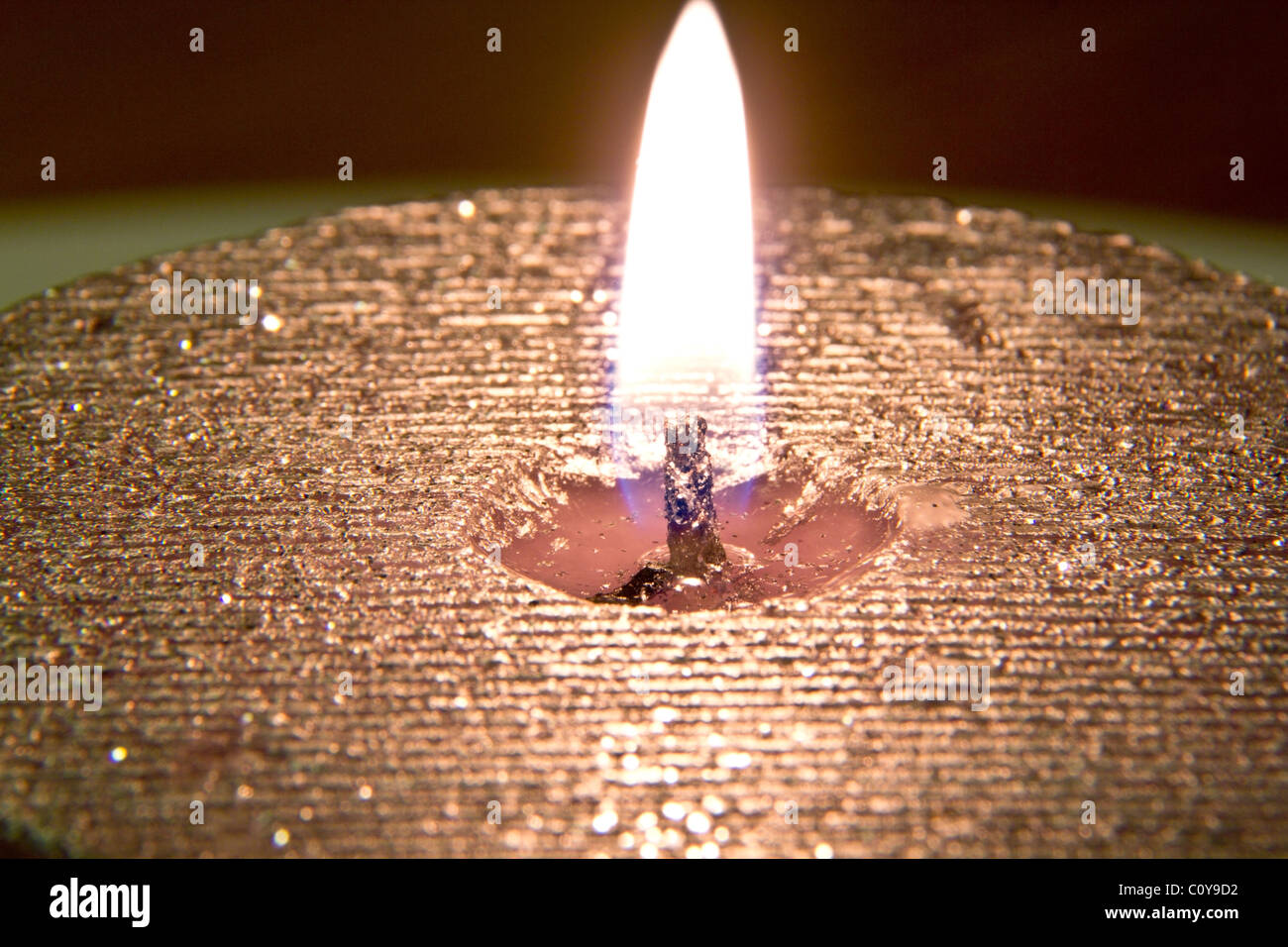 Sparkling silver and gold colored candle burning brightly Stock Photo ...