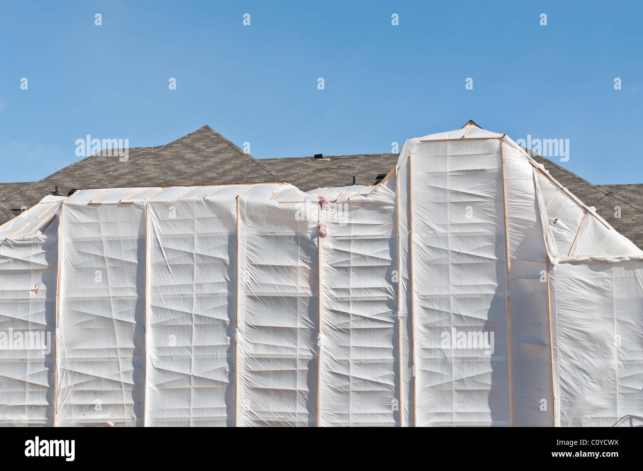 A heated plastic enclosure allows bricks to be laid during the cold ...