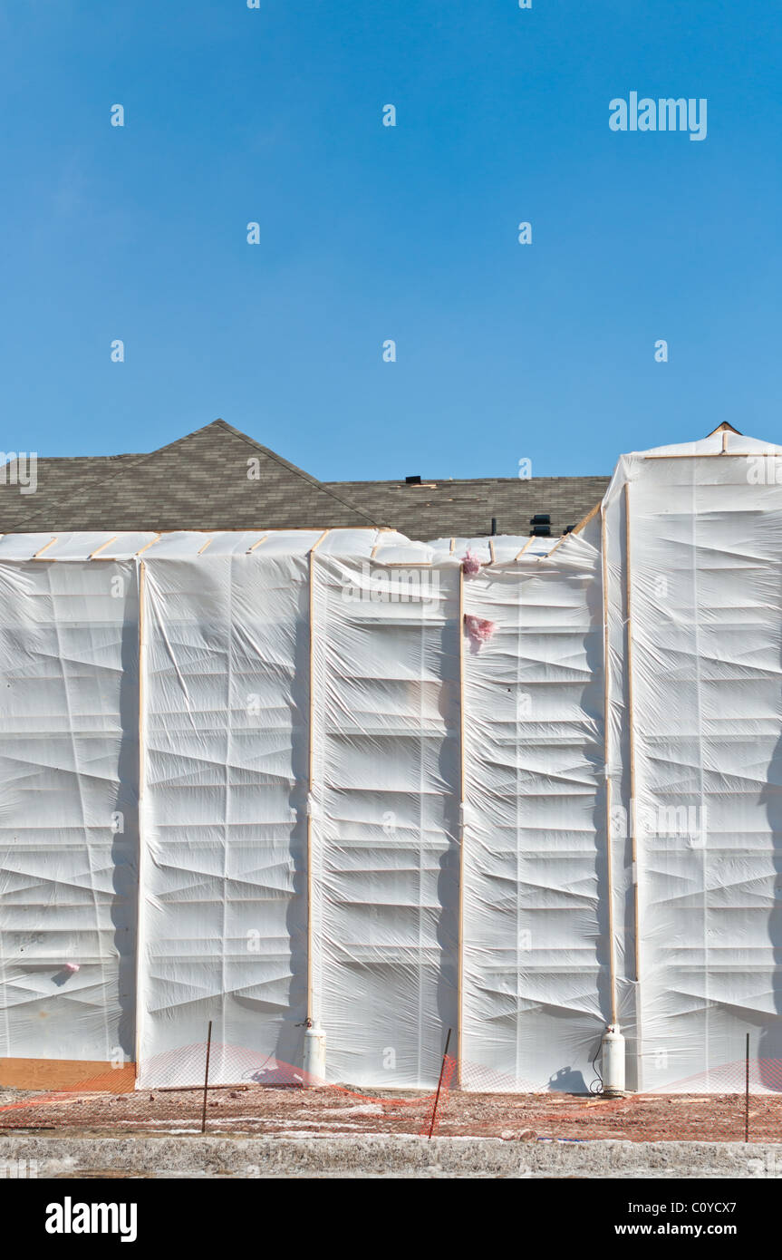 A heated plastic enclosure allows bricks to be laid during the cold ...