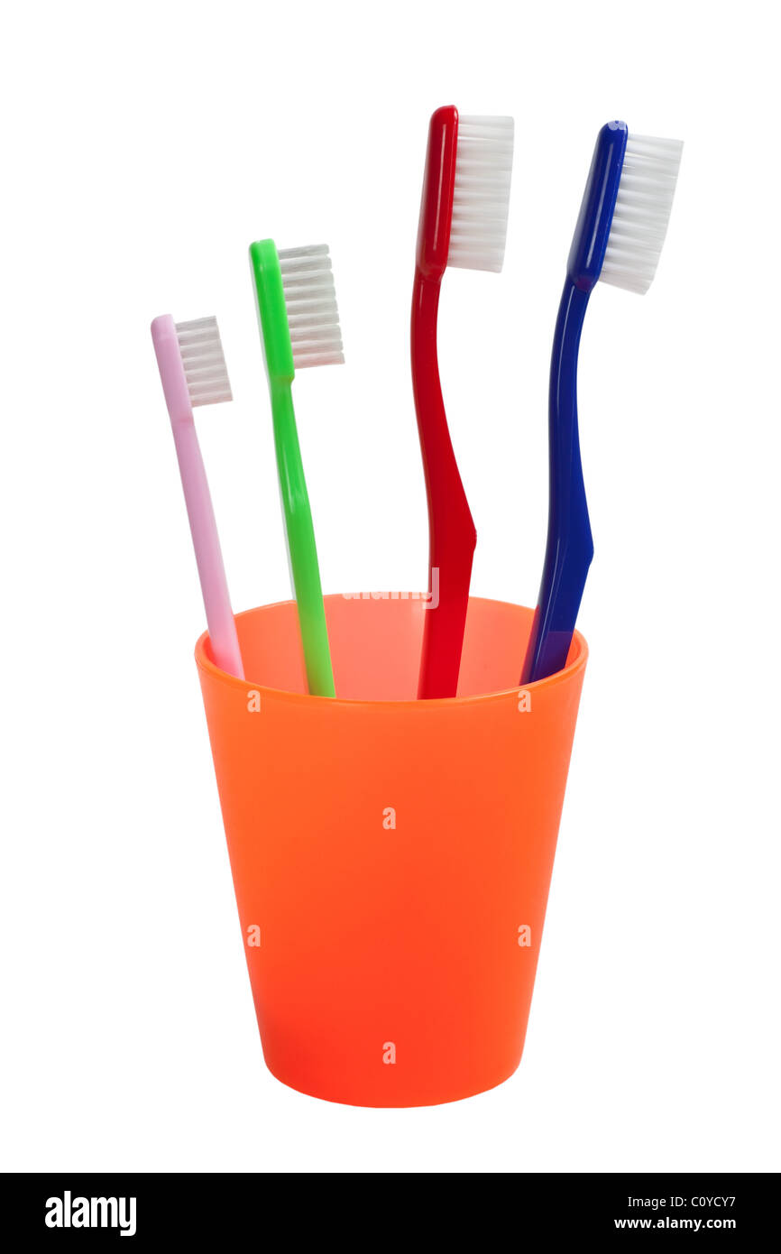 Family of different size toothbrush in a cup isolated on white ...