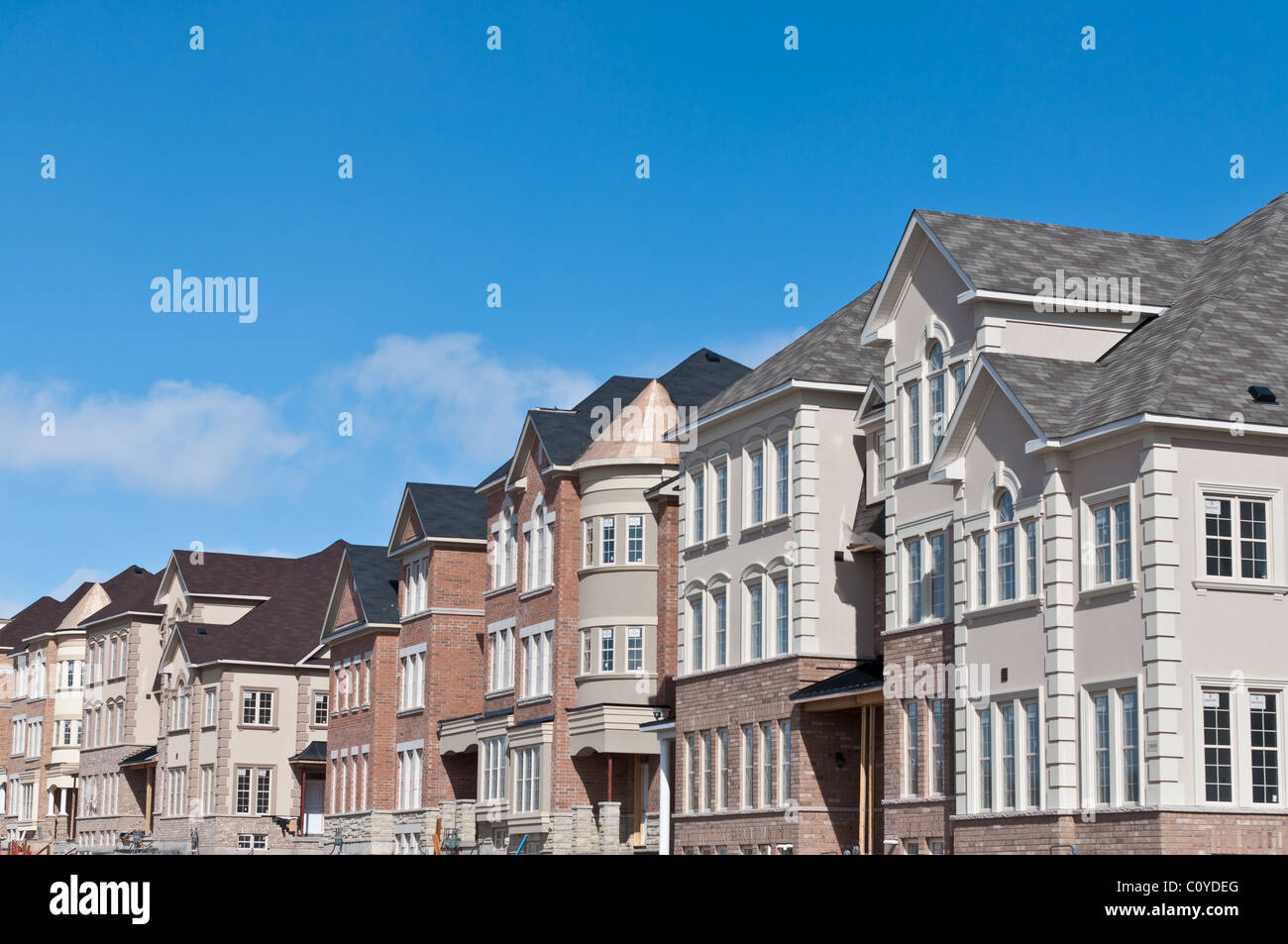 A newly built row of townhouses nears completion Stock Photo - Alamy