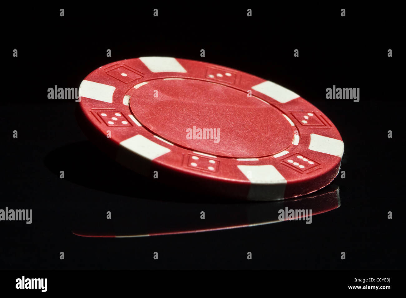 Red chip on black reflection table Stock Photo - Alamy