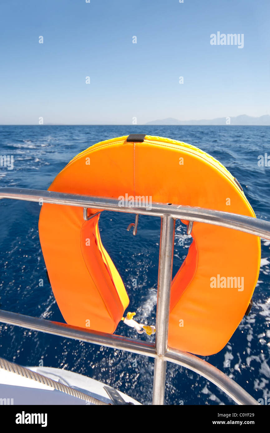 Orange lifebuoy on sailing ship and blue sea Stock Photo - Alamy