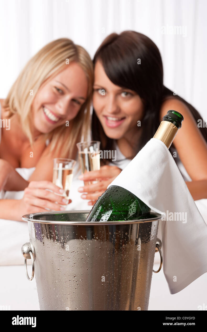 Two young women toasting with champagne in luxury hotel room Stock ...