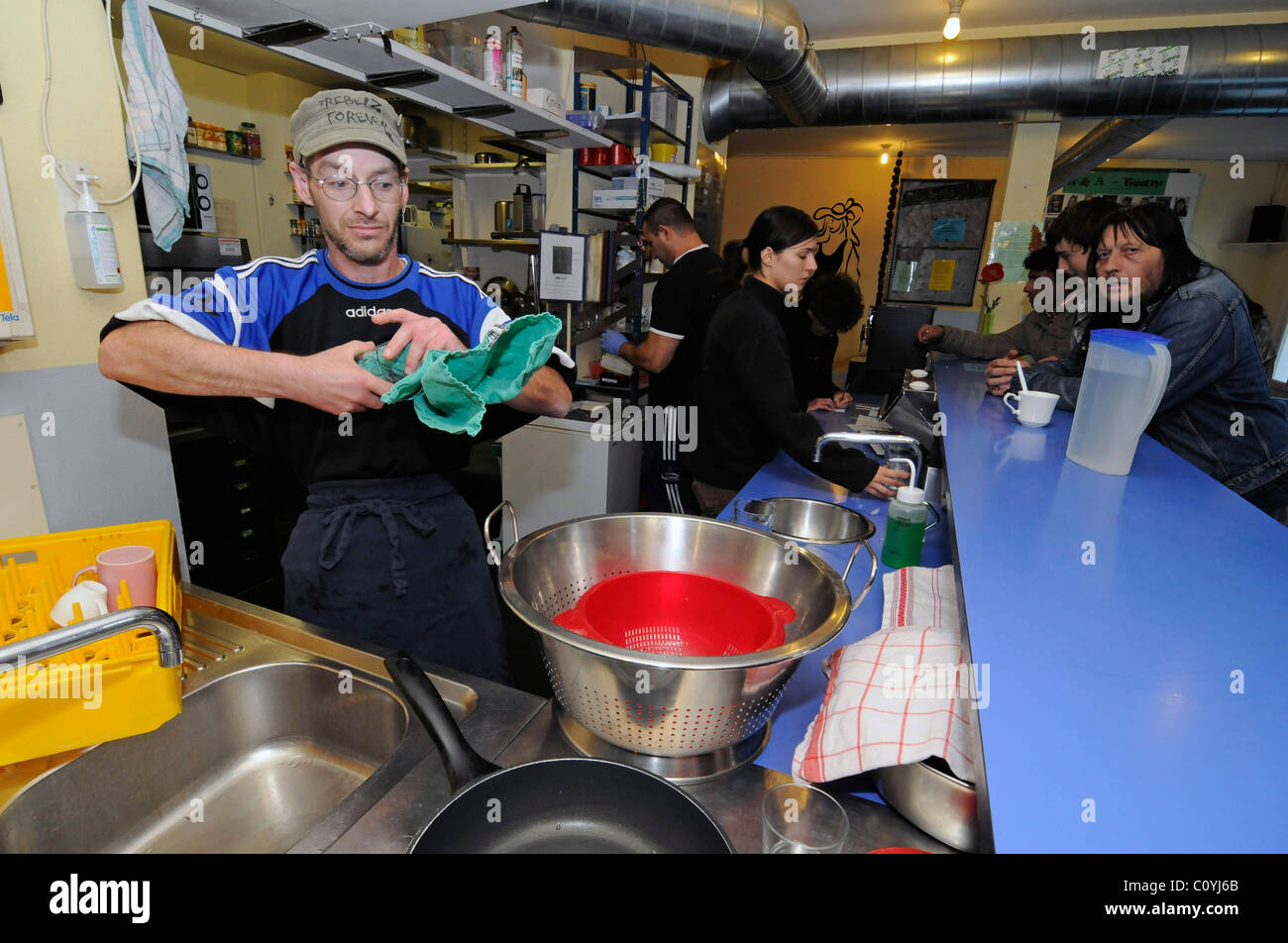 A drug addict helping out with cleaning dishes and serving diner to ...