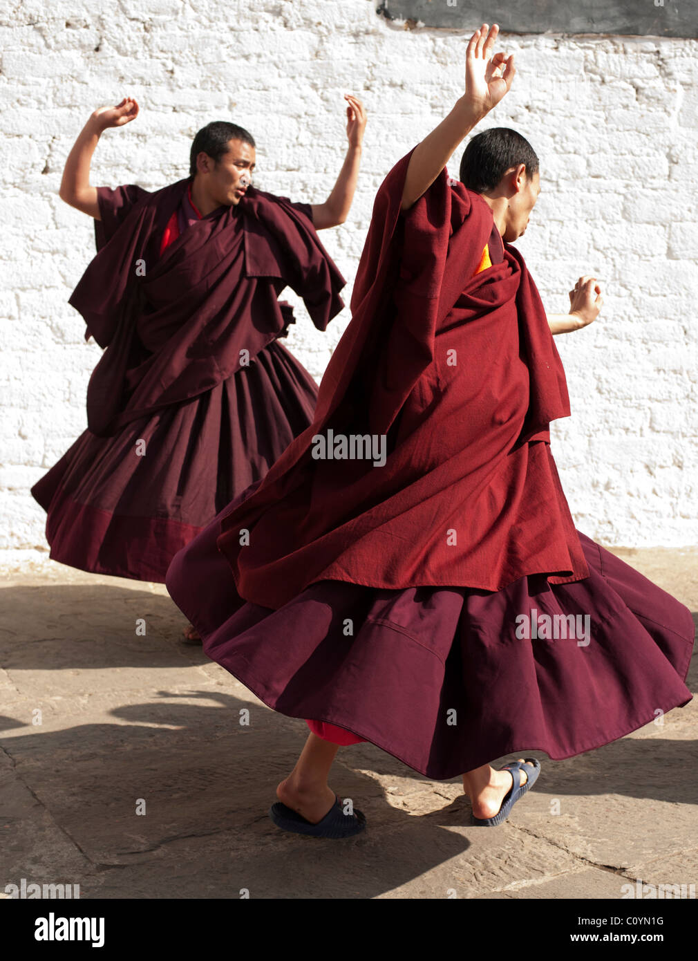 Bhutanese monk(s) practicing dance steps prior to appearing in a major ...
