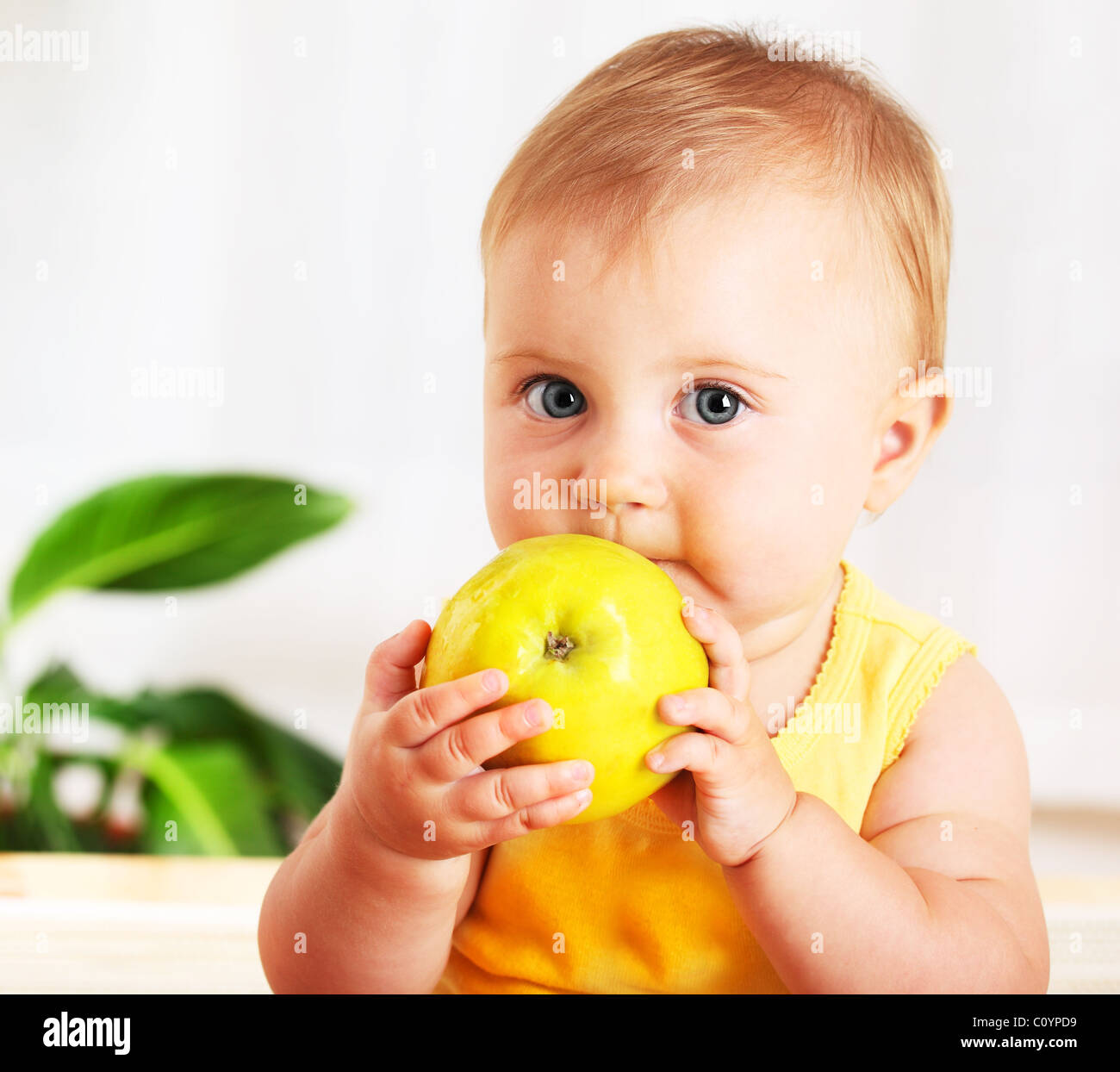 Little baby eating apple, closeup portrait, concept of health care ...