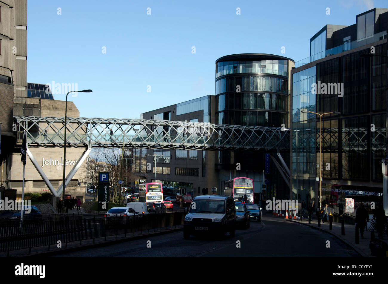 People (not recognisable) crossing a modern pedestrian bridge in ...