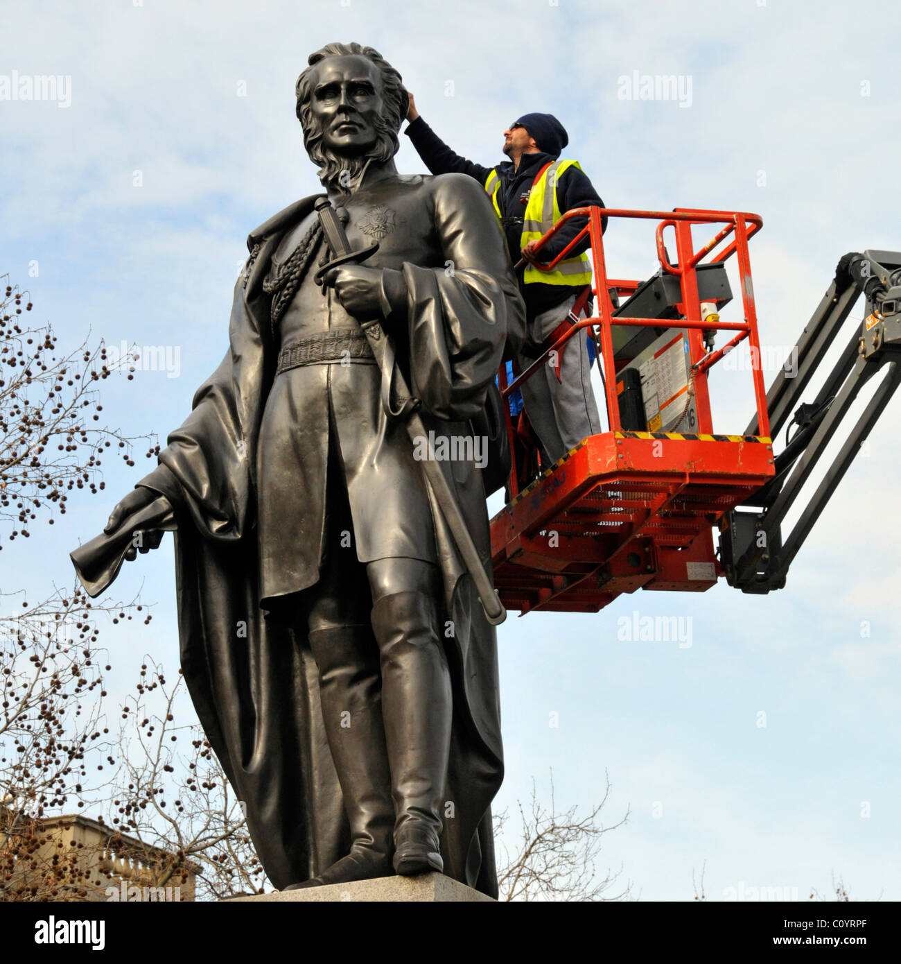Cleaners on a Cherry Picker access platform cleaning bronze statue ...