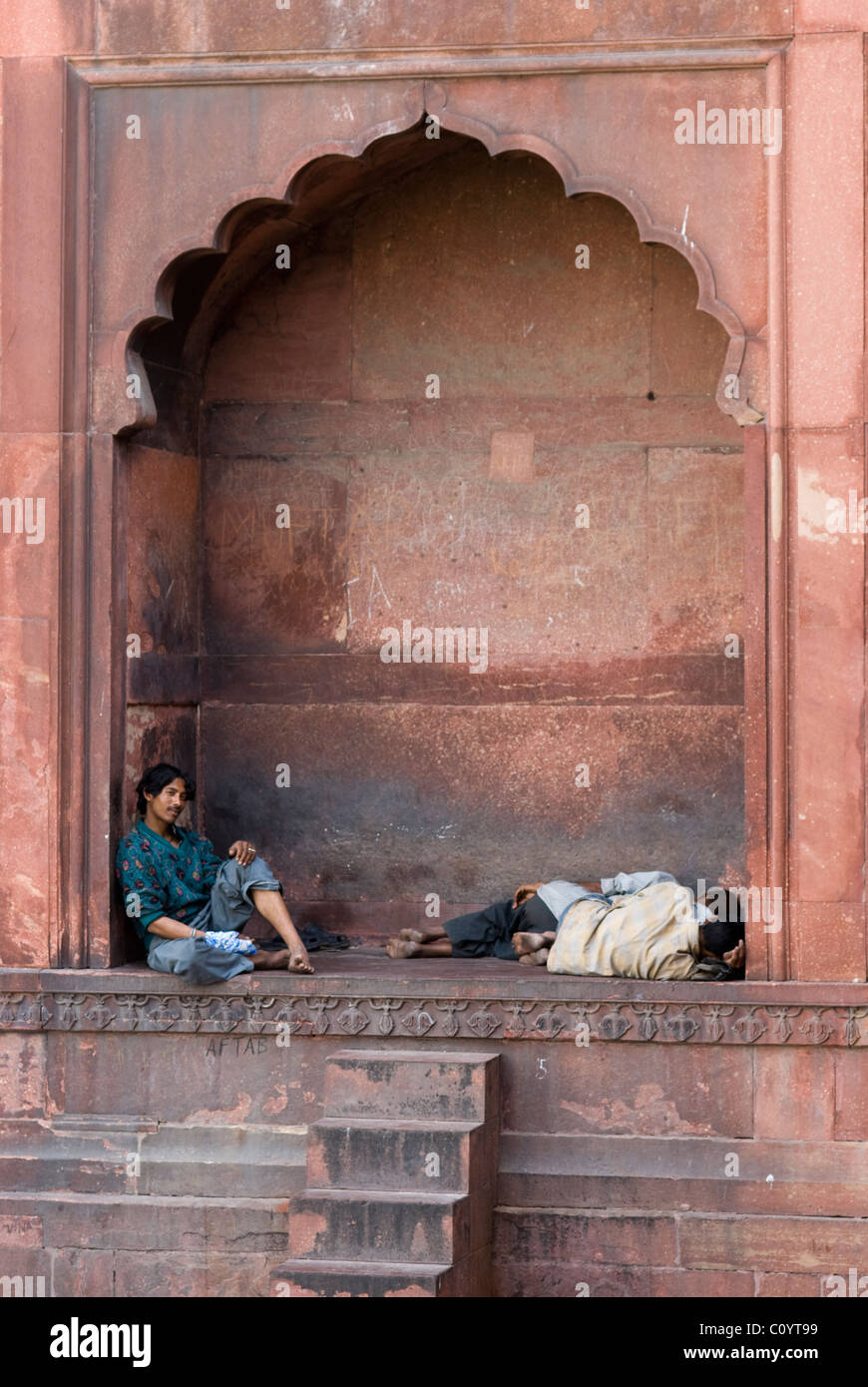 Indian man resting/ sleeping inside a beautiful arch Stock Photo - Alamy