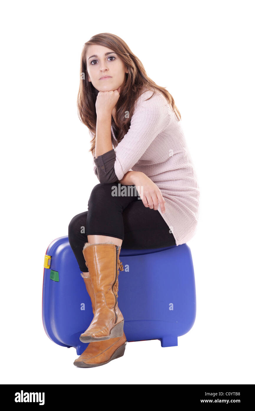 traveling concept young woman sitting on her suitcase on white ...