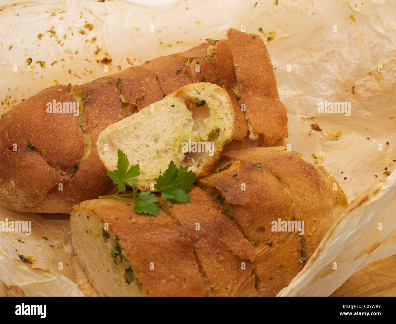Home made Garlic bread in baking paper with chopped parsley Stock Photo ...