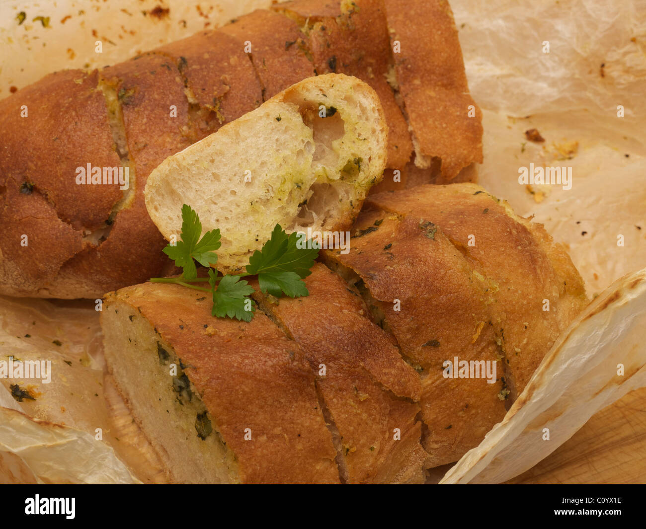 Home made Garlic bread in baking paper with chopped parsley Stock Photo ...