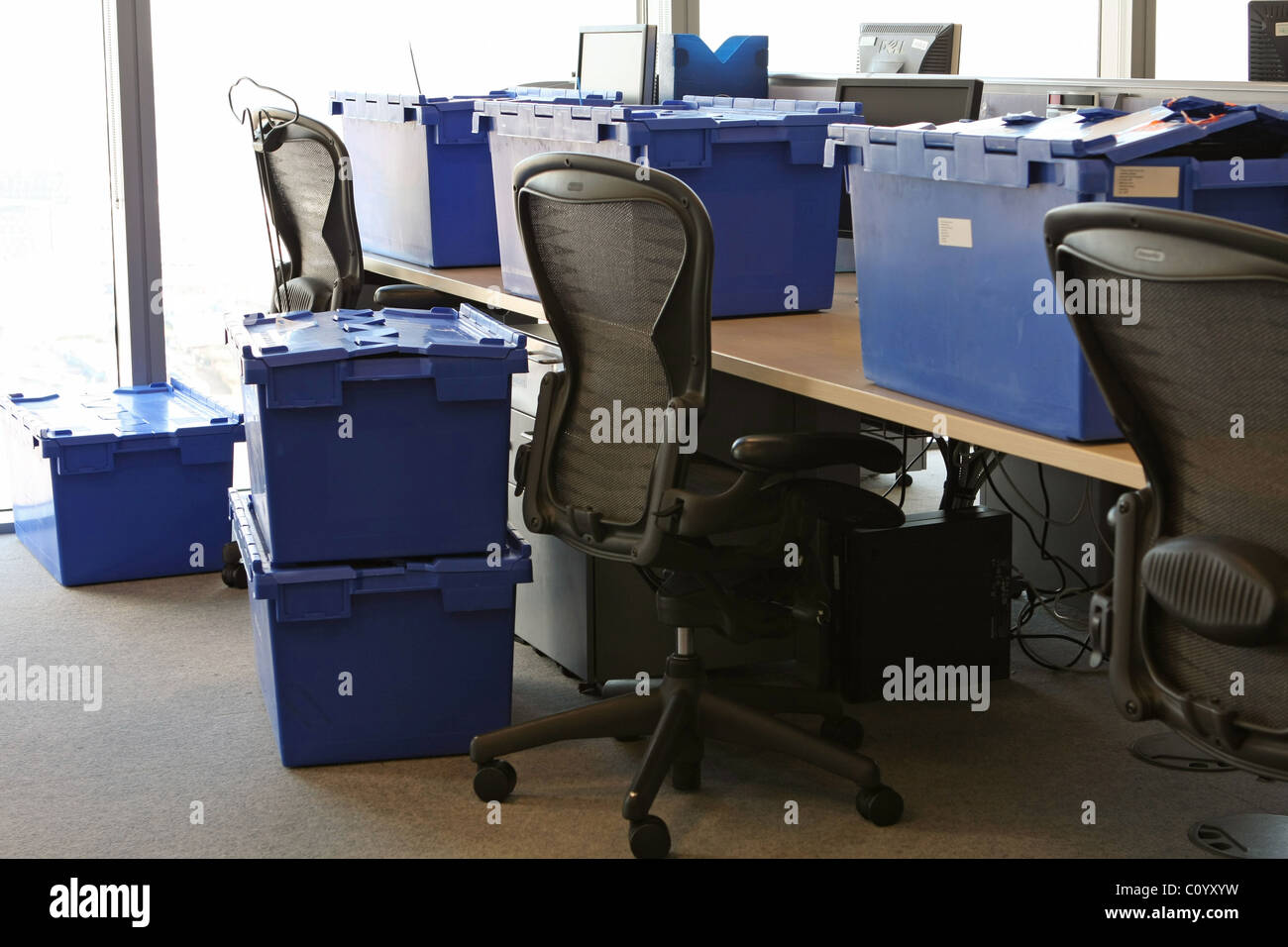 Blue removal boxes in an office Stock Photo - Alamy
