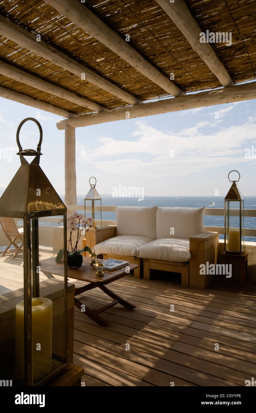 Wooden floored terrace with bamboo awning, moroccan lanterns and ...
