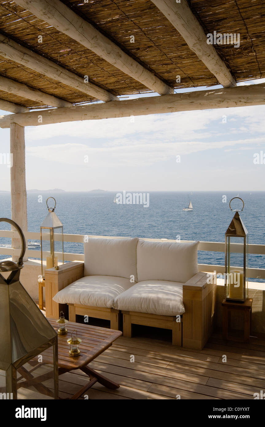 Wooden floored terrace with moroccan lanterns, bamboo awning and ...