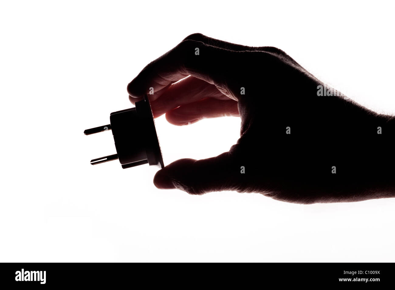 Hand Holding an Electric Adapter Plug on a white background Stock Photo ...
