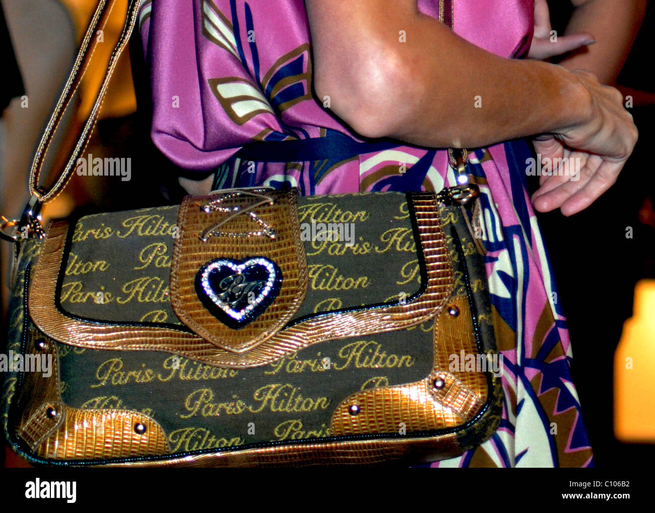 Paris Hilton carrying one of her own Paris Hilton handbags while ...