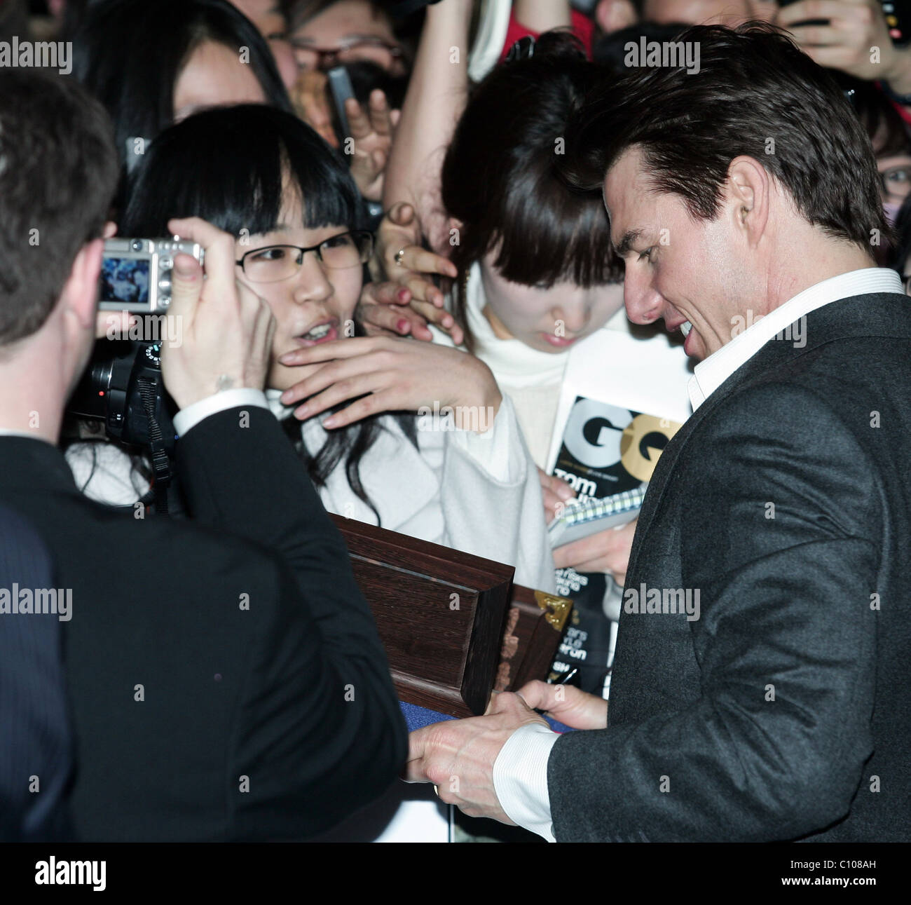 Tom Cruise signs autographs for waiting fans and poses for photographs ...