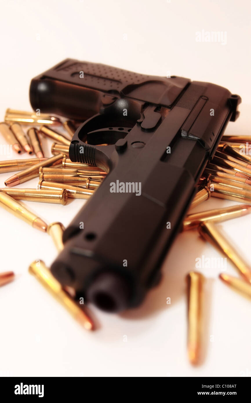 gold ammo and a handgun depicting gun culture Stock Photo - Alamy