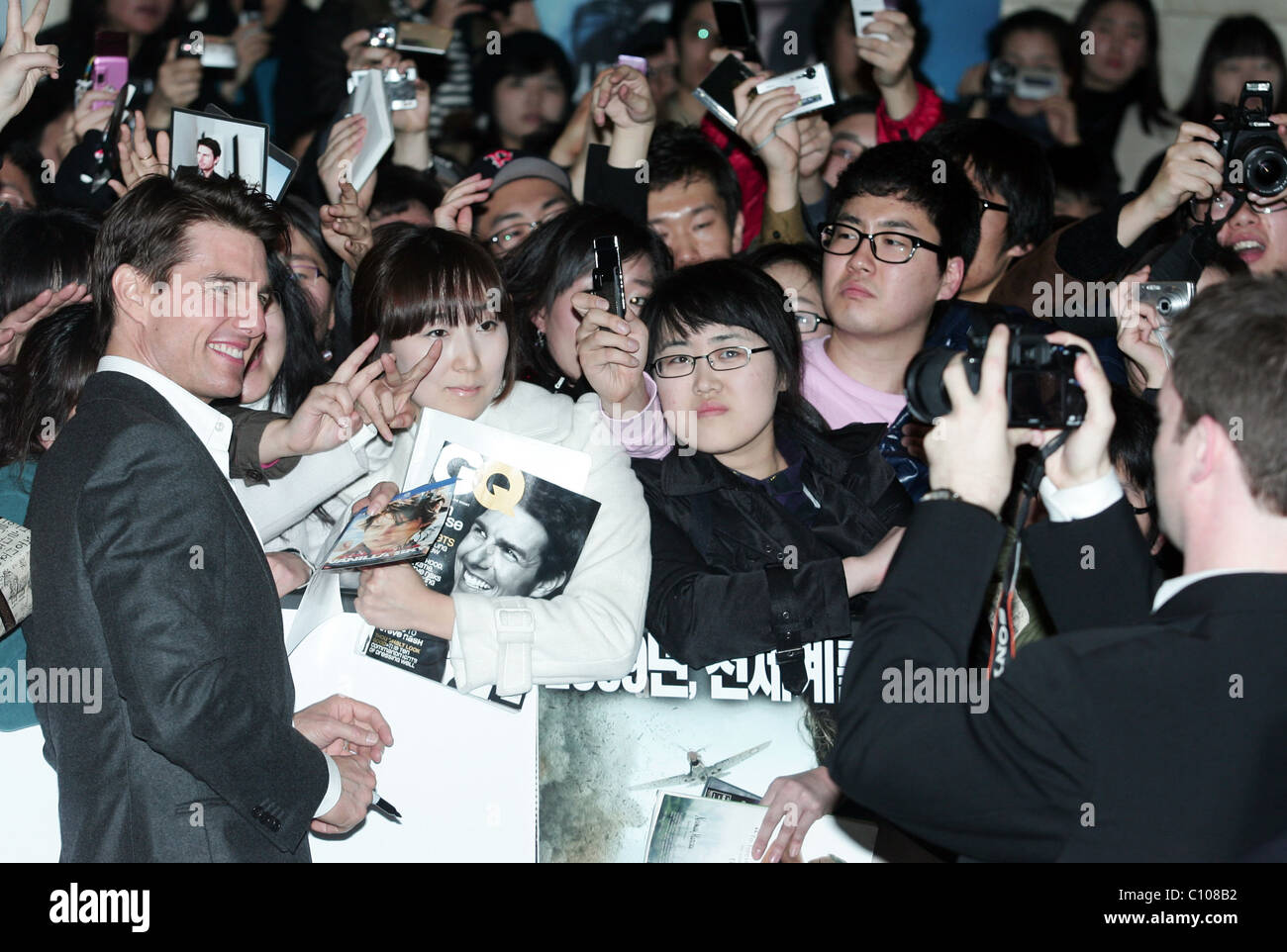 Tom Cruise signs autographs for waiting fans and poses for photographs ...