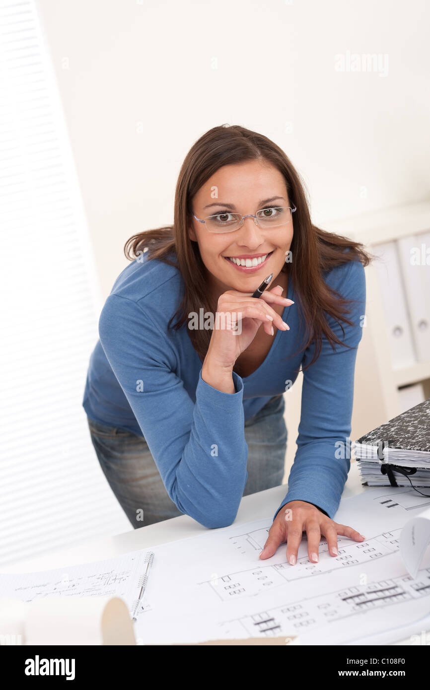 Young female architect working at the office Stock Photo - Alamy