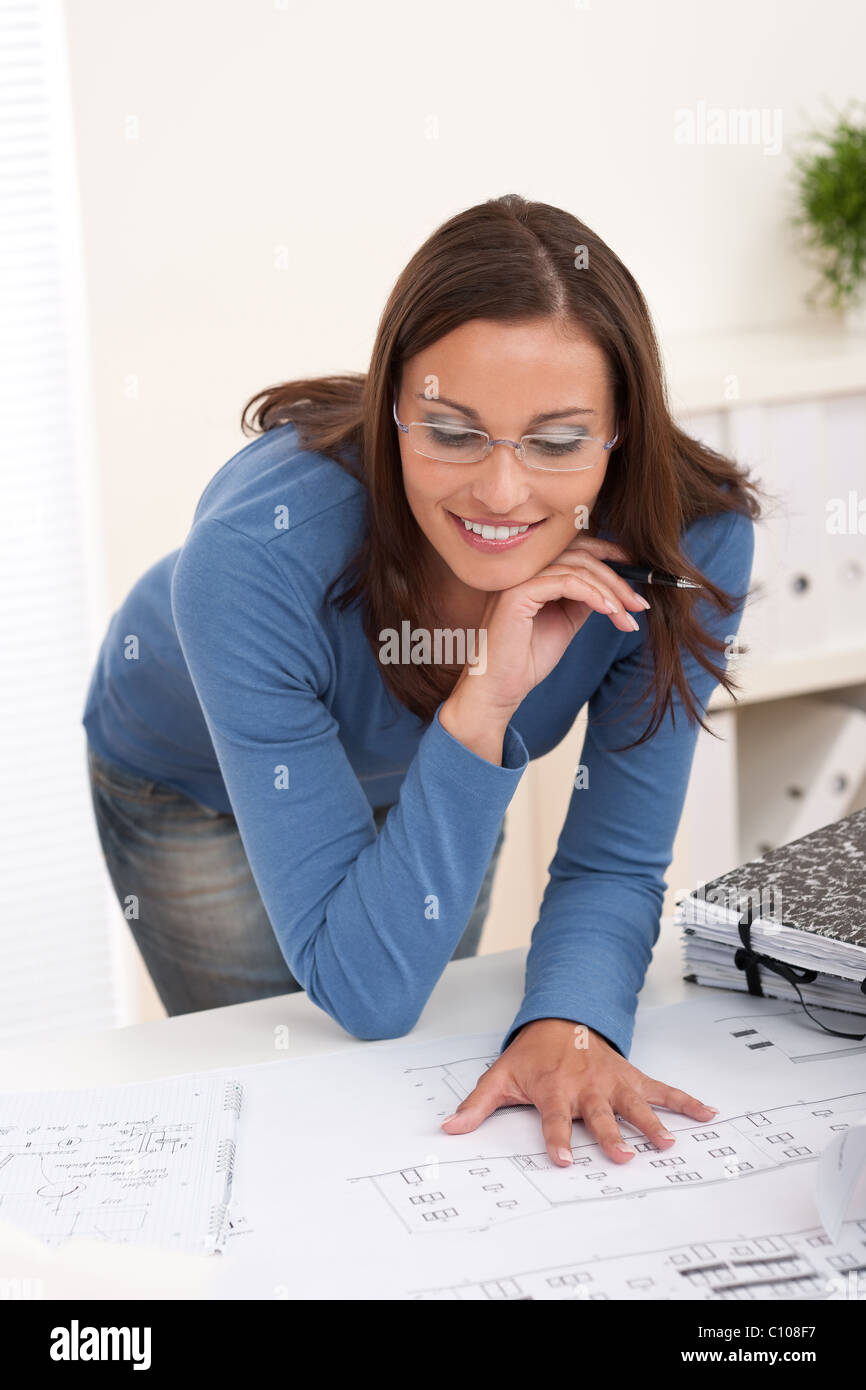Young female architect working at the office Stock Photo - Alamy