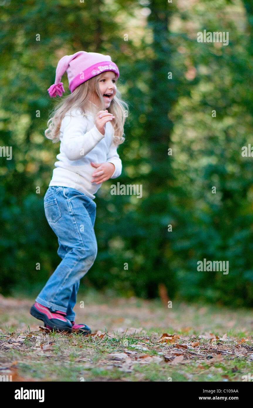 Happy girl running in the park Stock Photo - Alamy