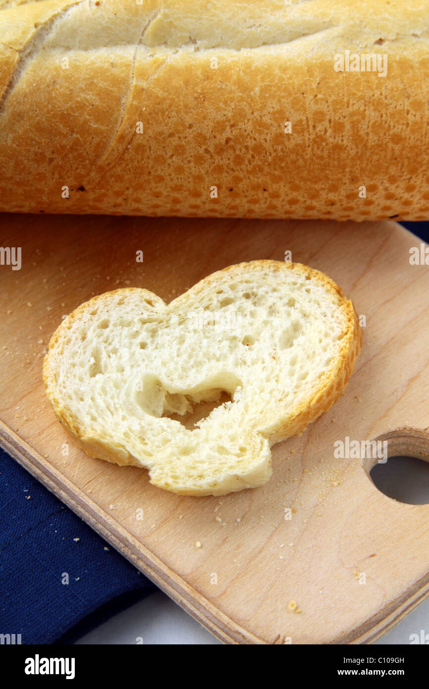 Fresh piece of bread in a heart shaped hi-res stock photography and ...