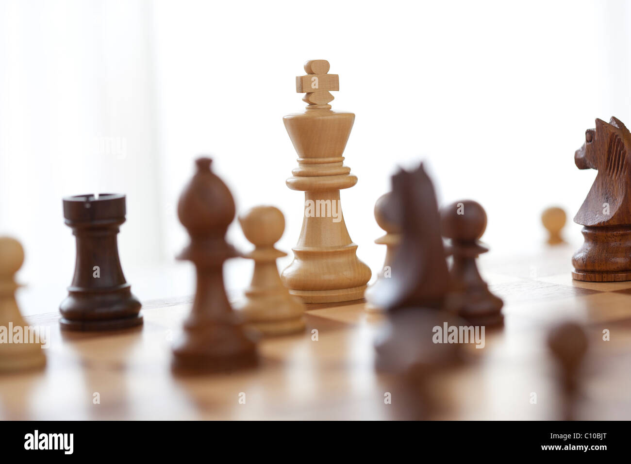 game of chess from eye level with king surrounded Stock Photo - Alamy