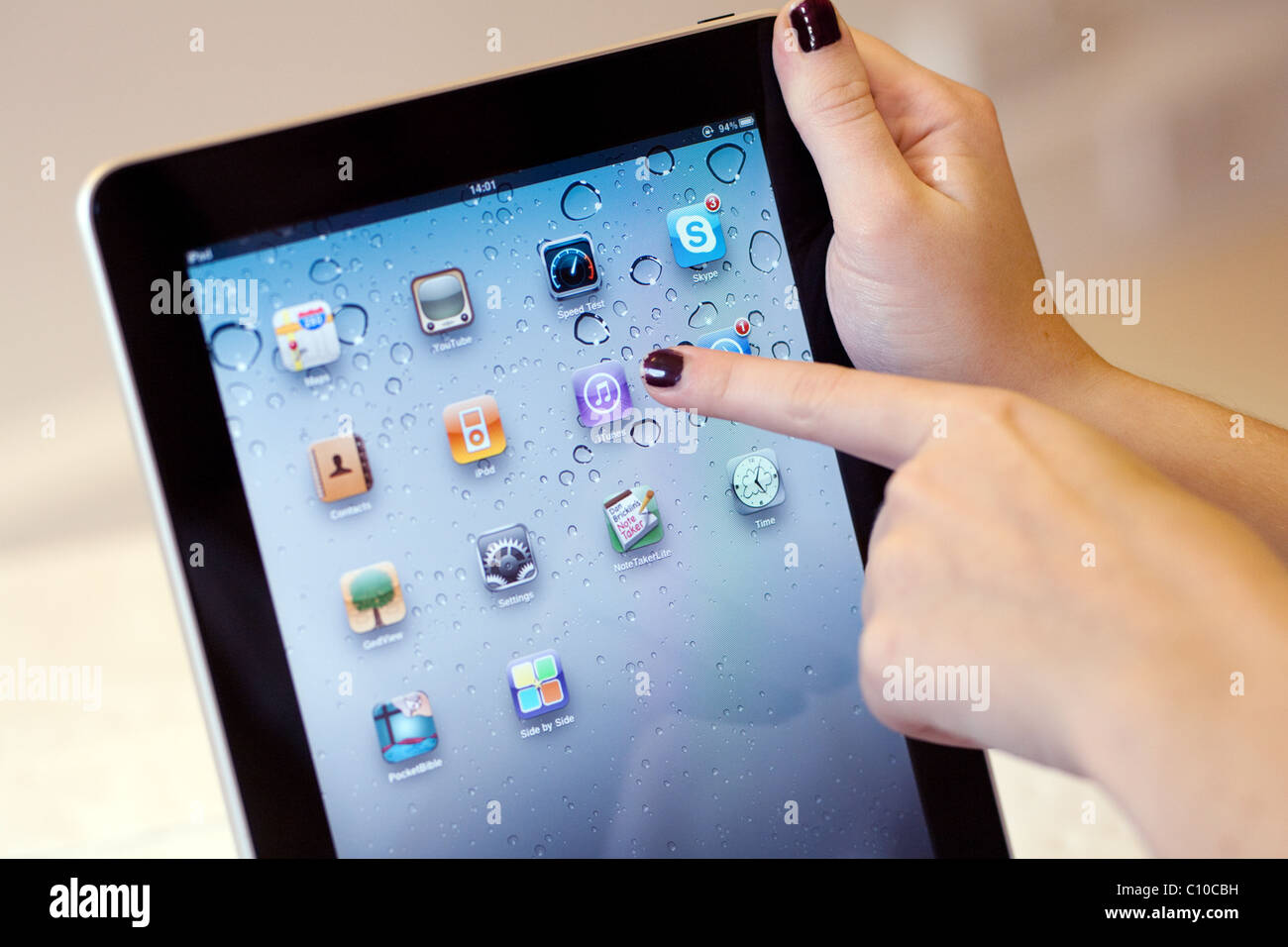 Close up of Apple iPad with a finger pointing at the iTunes app Stock ...