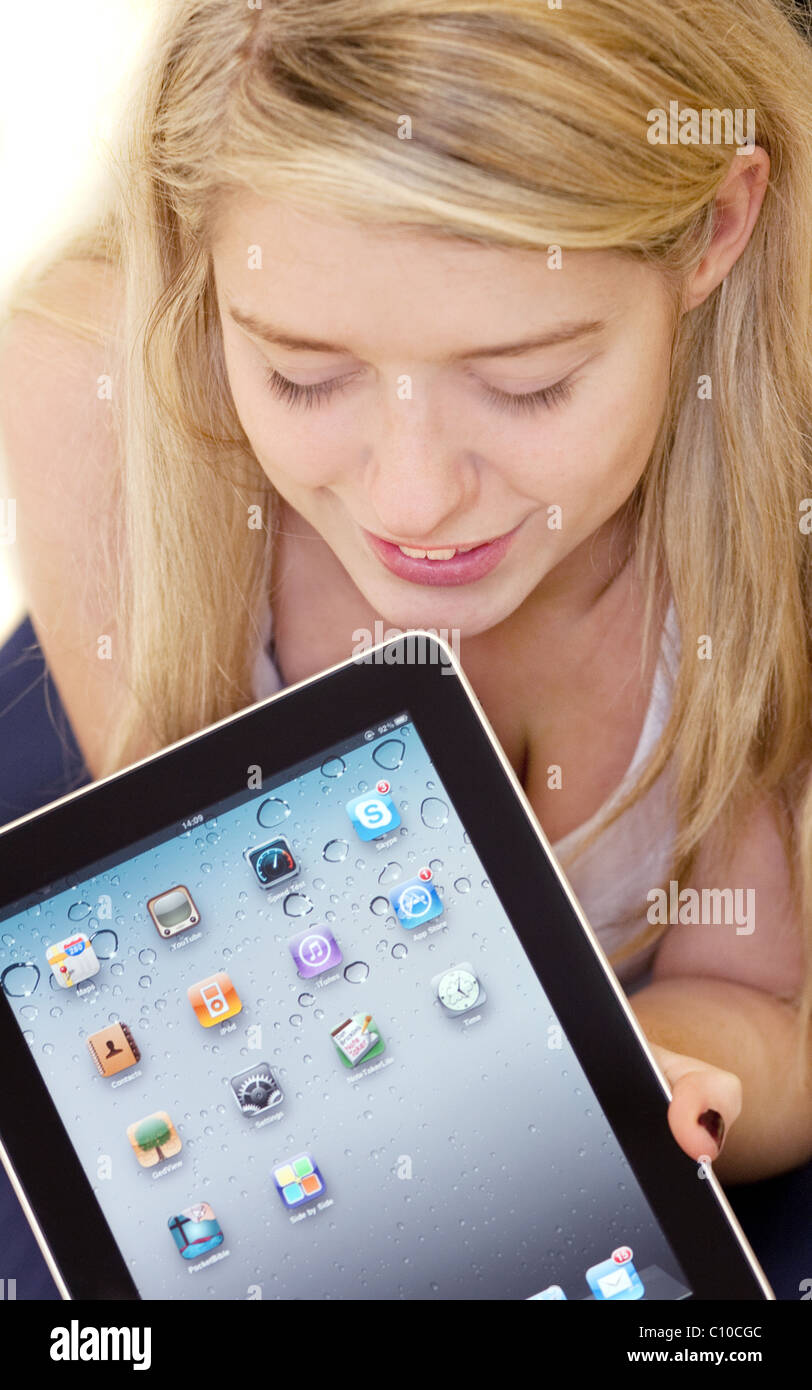 Attractive blond teenage girl holding an Apple iPad Stock Photo - Alamy