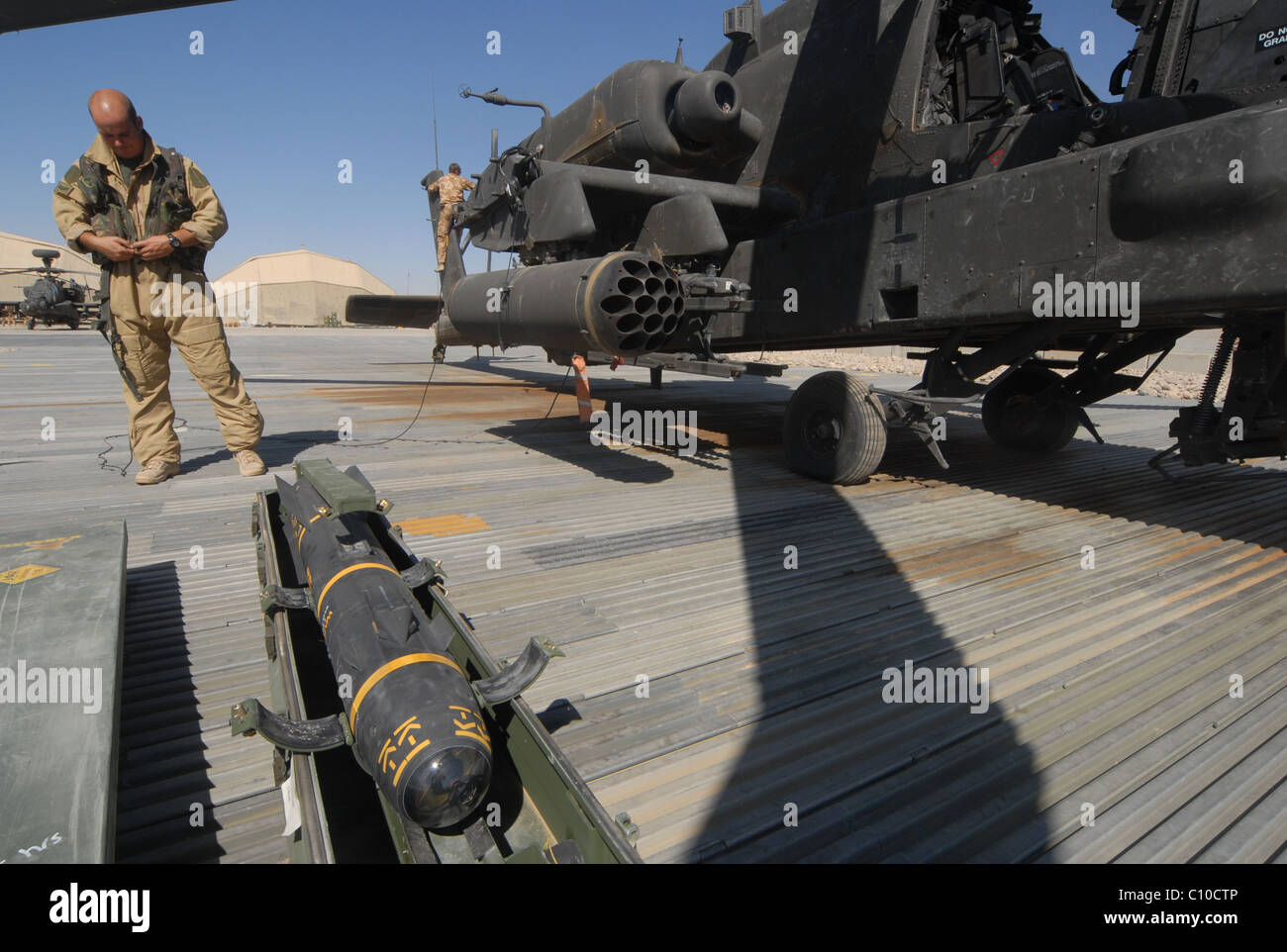 a missile is loaded on to a British apaches helicopter in camp bastean ...