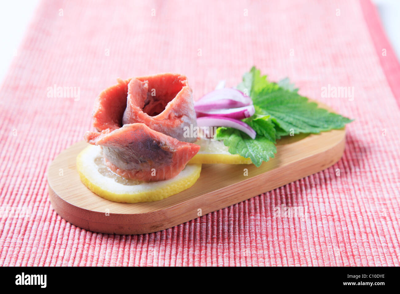 Matjes herring fillet with slices of lemon and onion Stock Photo - Alamy