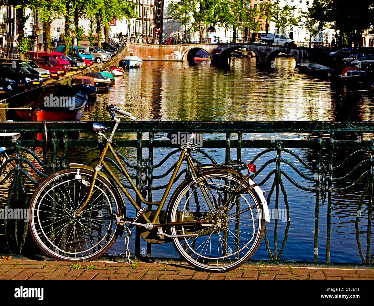 BICYCLE TIED TO CANAL BRIDGE RAIL IN AMSTERDAM, HOLLAND Stock Photo - Alamy